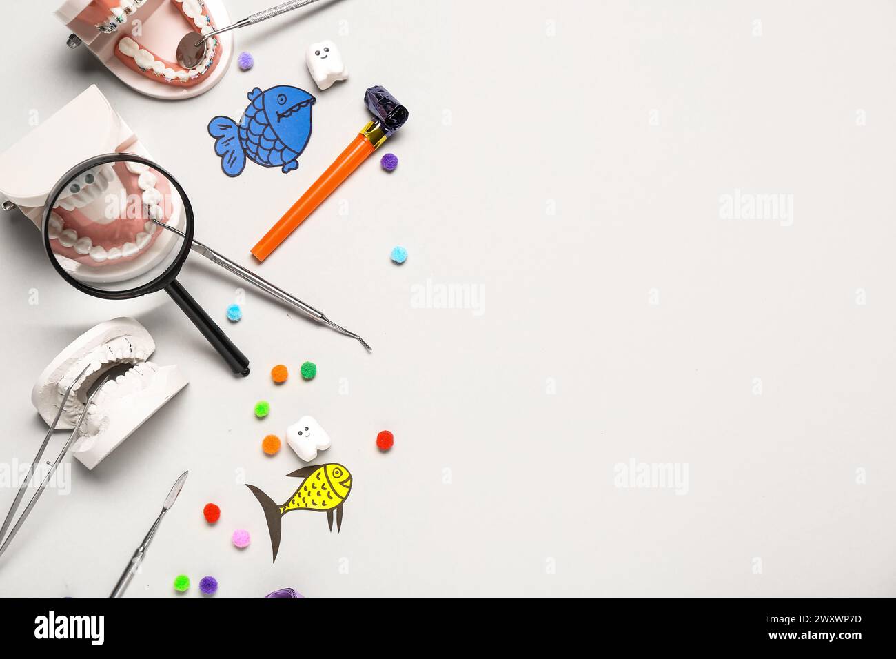 Composition with dentist's tools and decor for April Fools Day on light ...