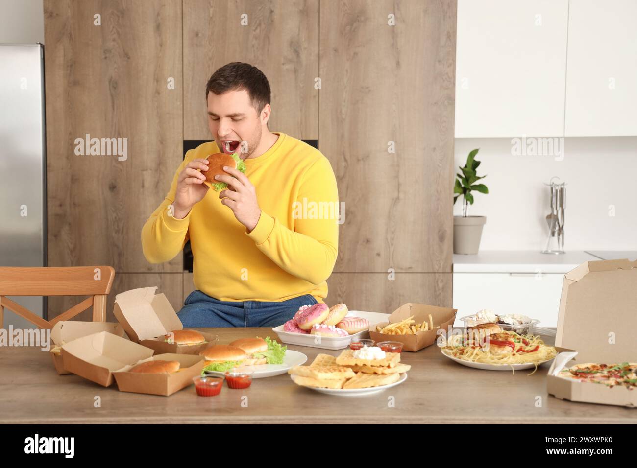 Man eating table full of food hi-res stock photography and images - Alamy