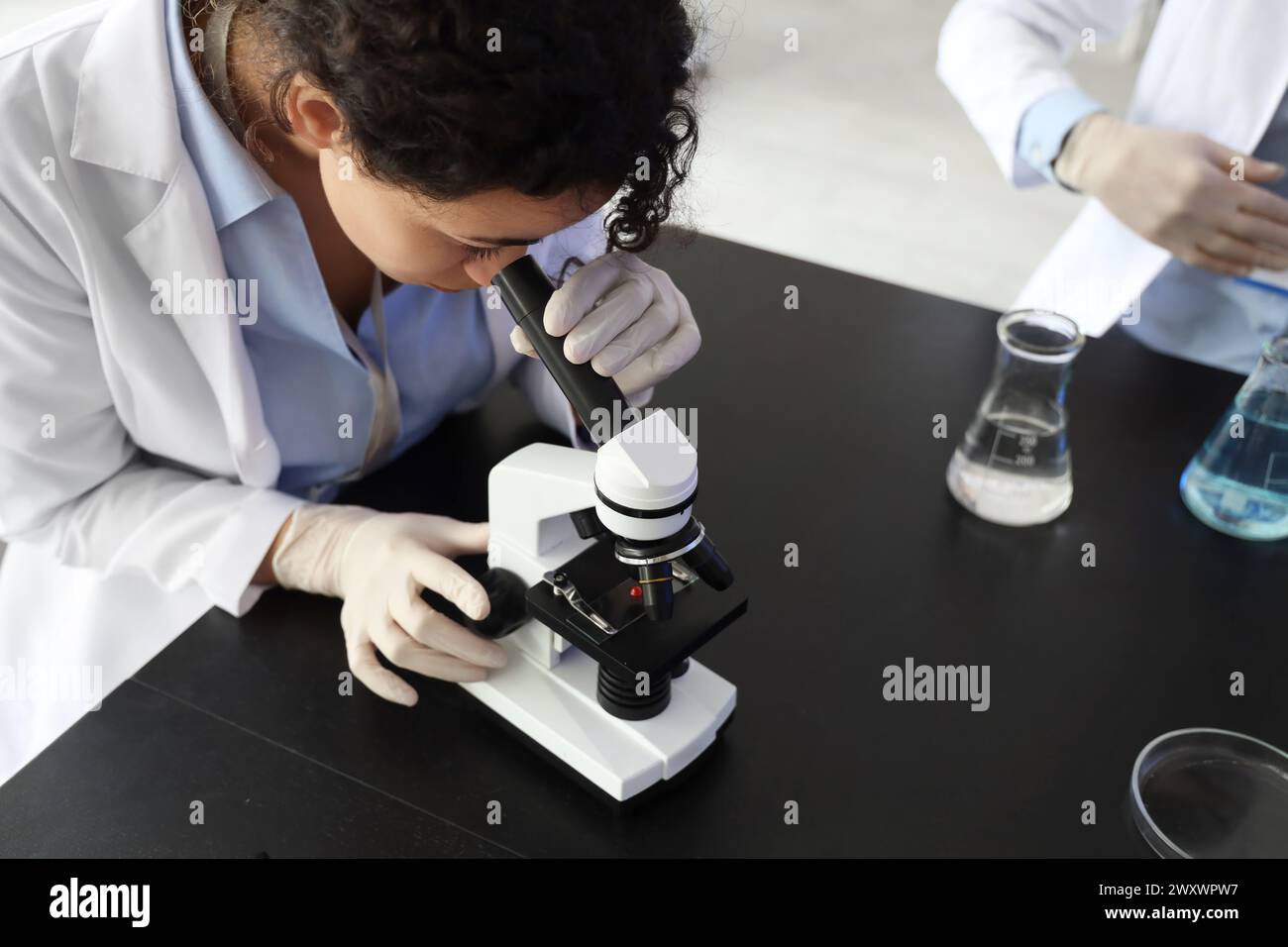 Female chemist working with microscope in laboratory, closeup Stock ...