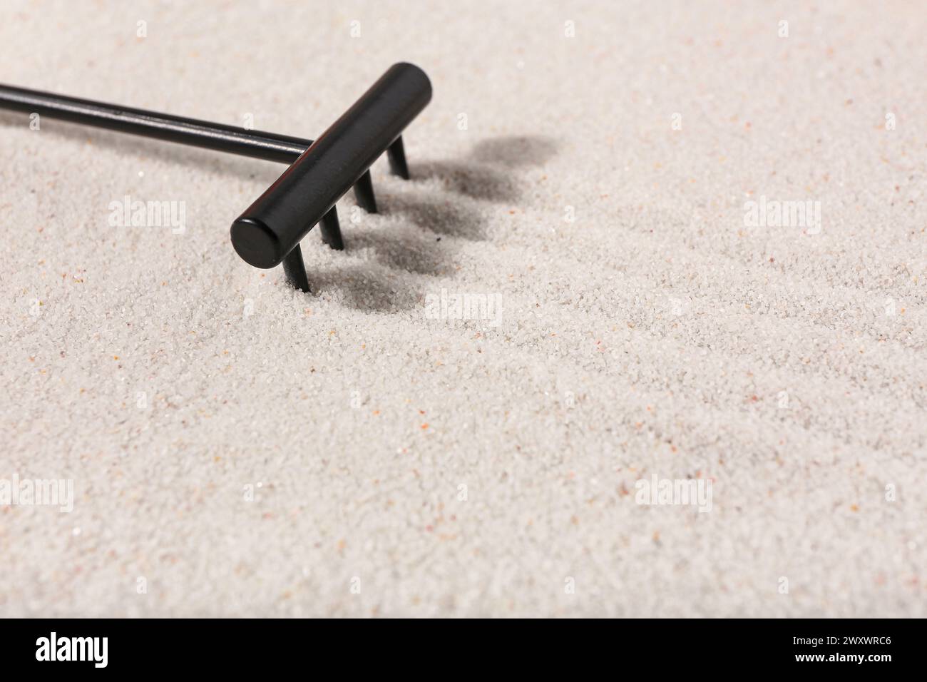Rake on sand with lines in Japanese rock garden, closeup. Zen concept ...