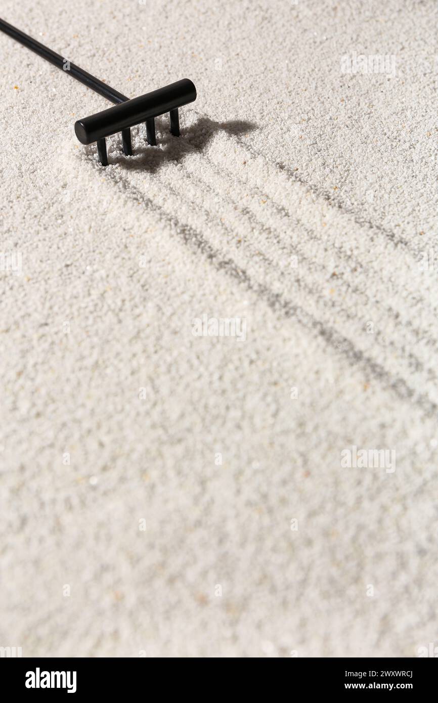 Rake making lines on sand in Japanese rock garden. Zen concept Stock ...
