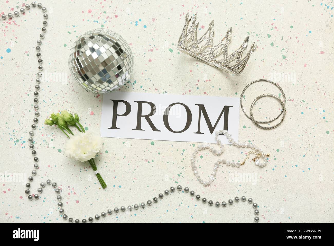 Word PROM with disco ball, boutonniere and accessories on light grunge ...