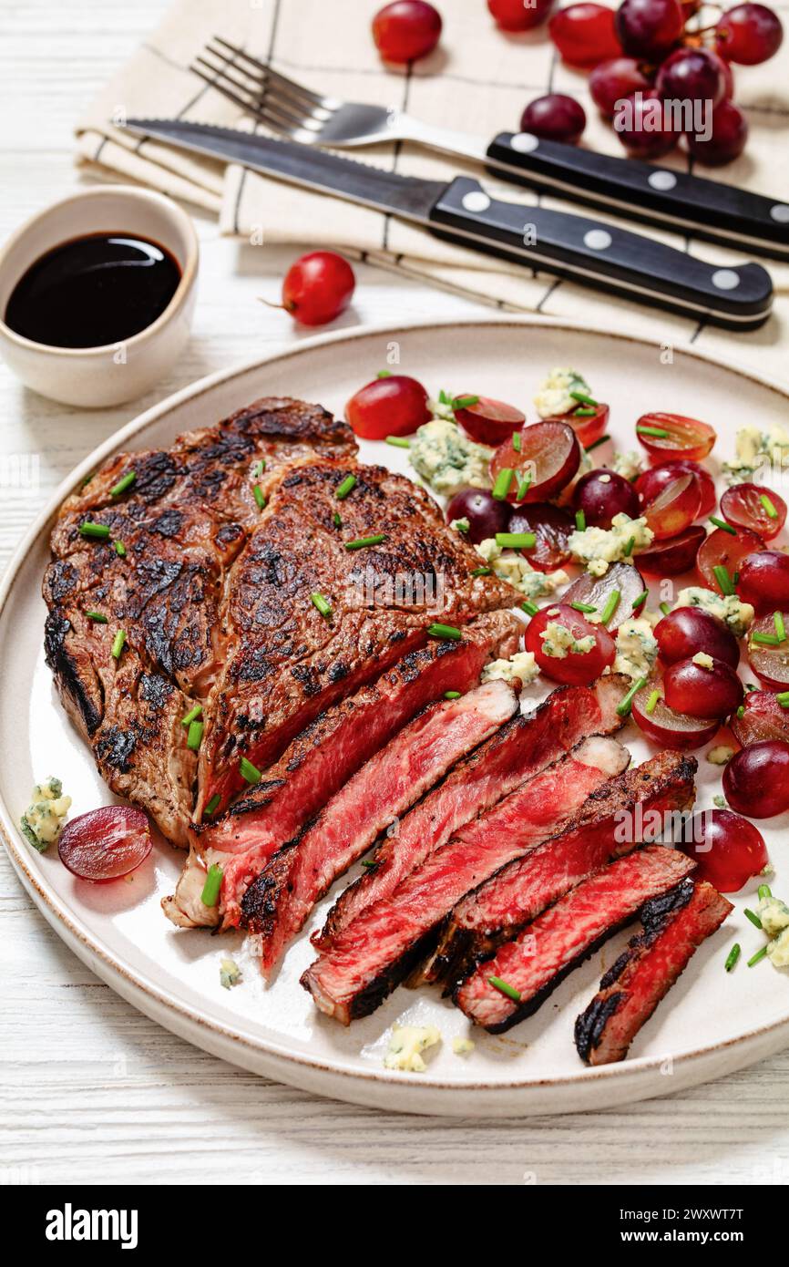 pan fried beef steak served with salad of red grape, crumbled blue mold ...