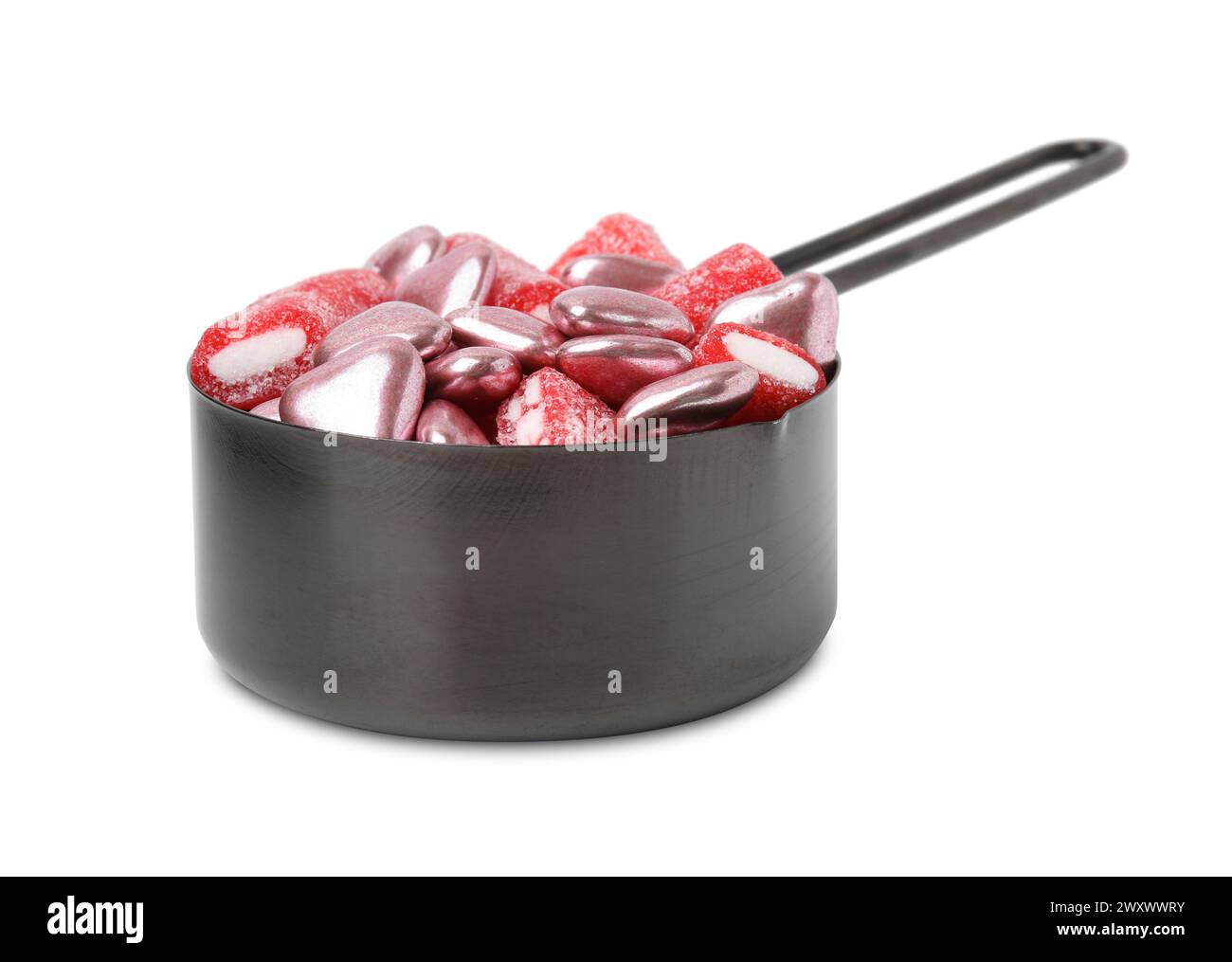 Yummy candies in measuring cup isolated on white Stock Photo - Alamy