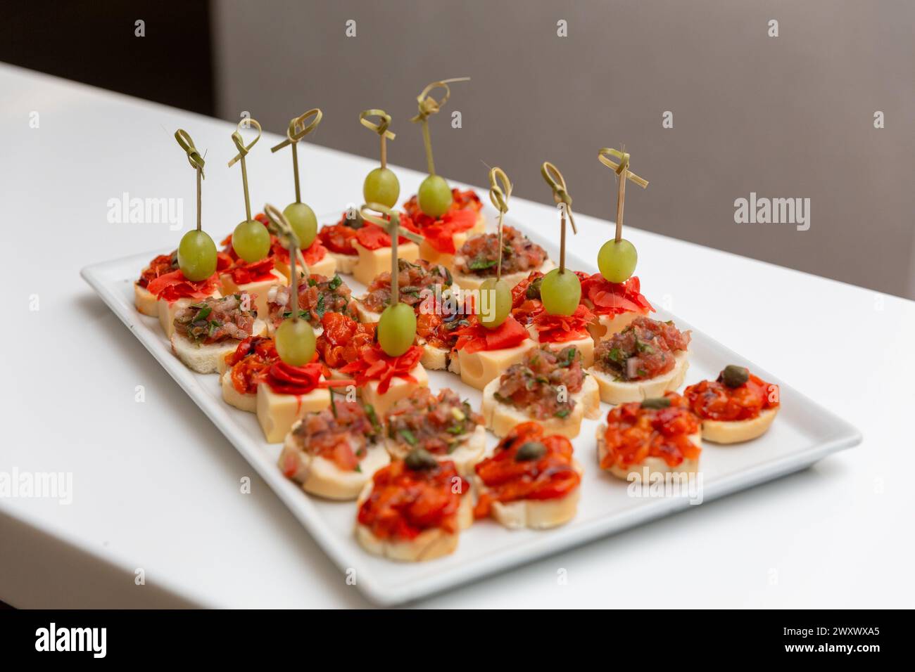 Plate with various seafood and meat canapes. Canape on white ceramic ...