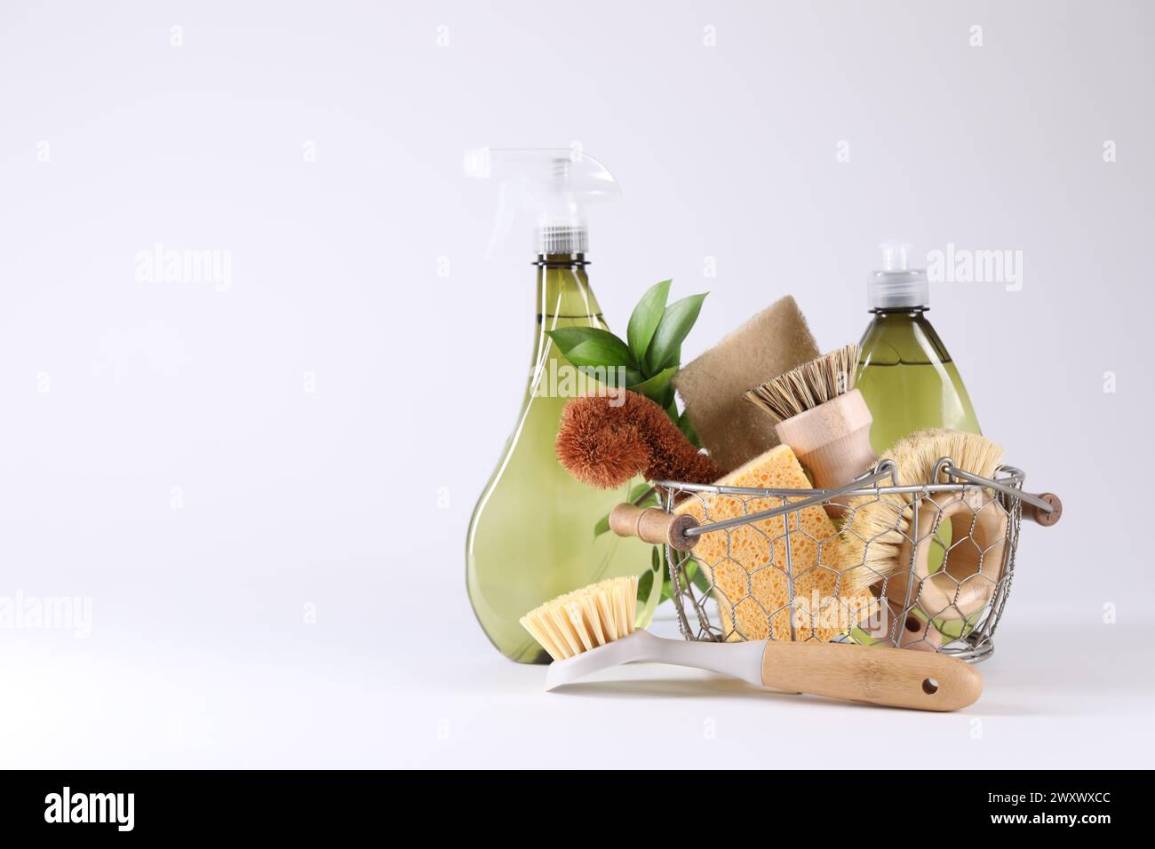 Set of different cleaning supplies in basket on white background Stock ...