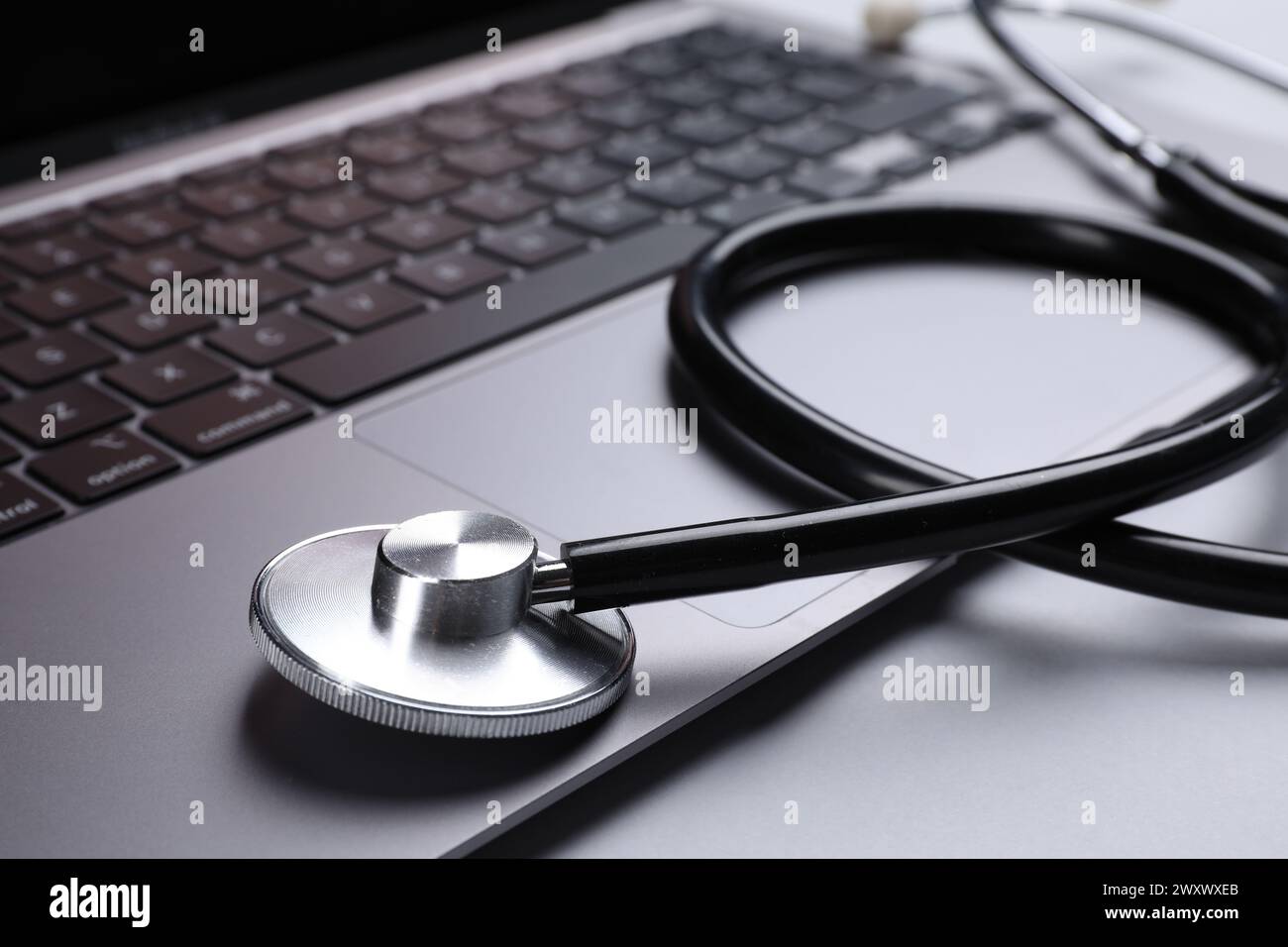 Laptop and stethoscope on light grey background, closeup Stock Photo ...