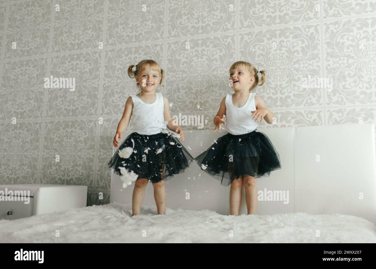 Two young girls wearing matching black and white tutus Stock Photo - Alamy