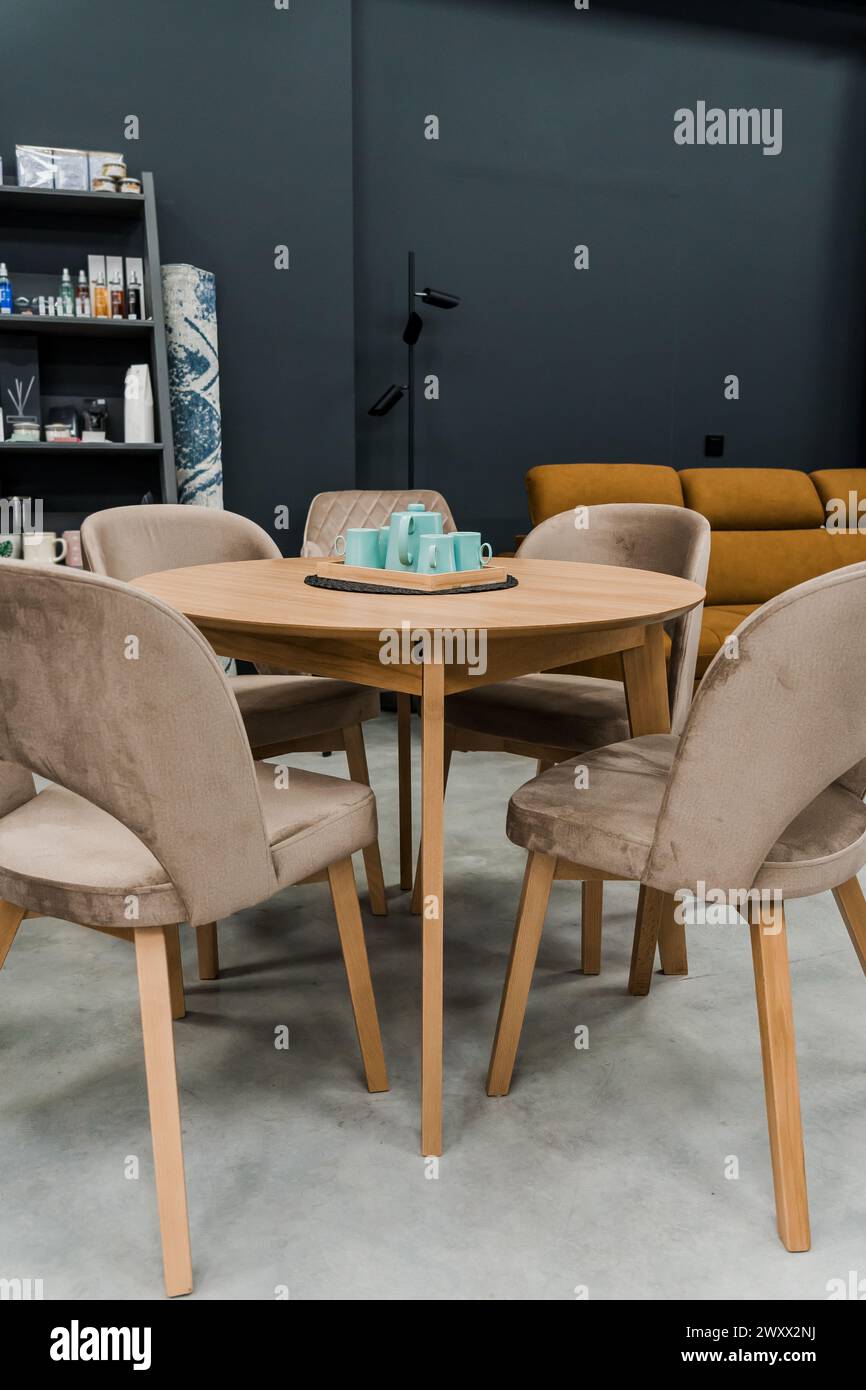 A yellow wooden table combined with beige wooden chairs with soft ...