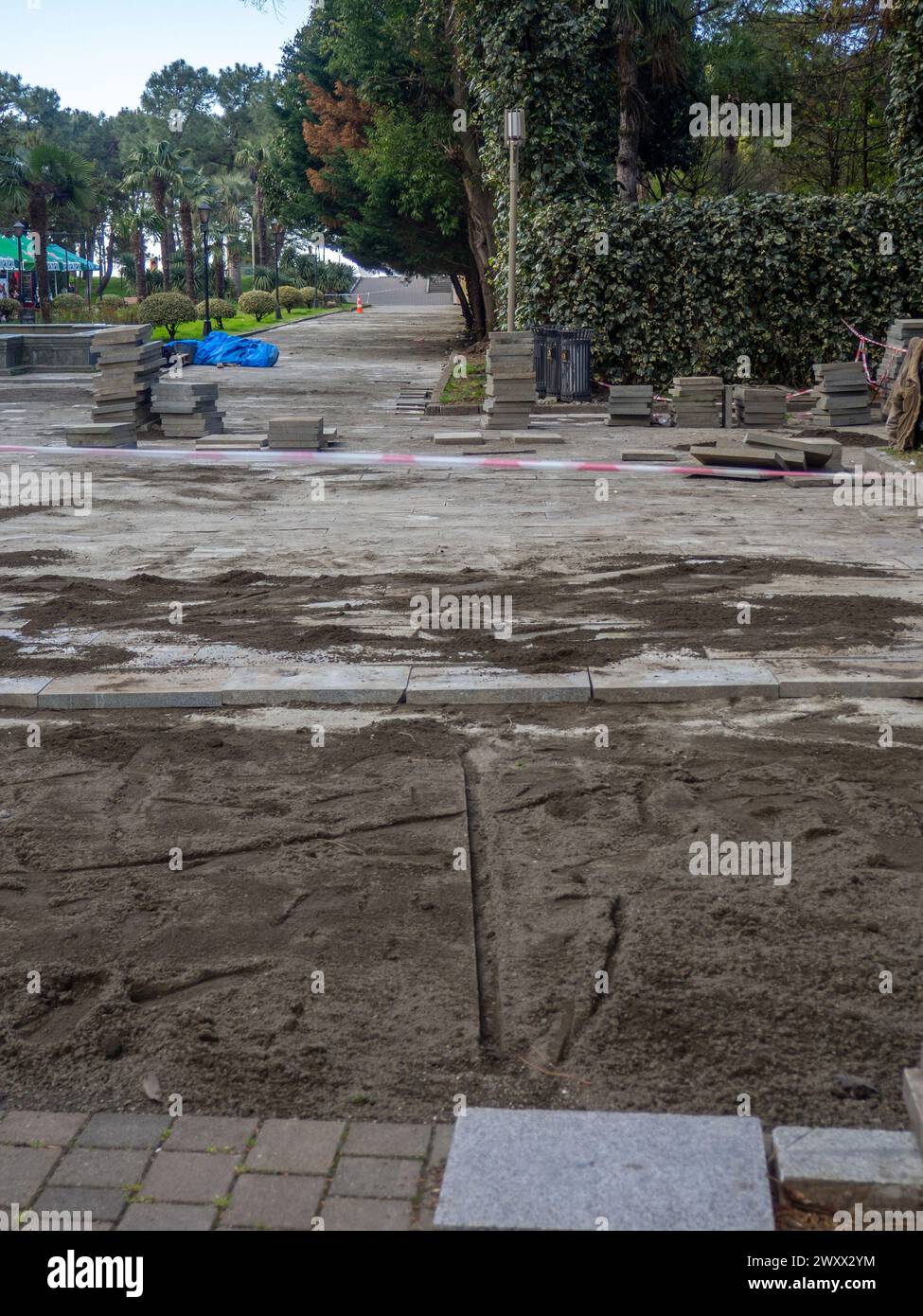 Laying tiles in the park. Maintenance of the infrastructure of the ...