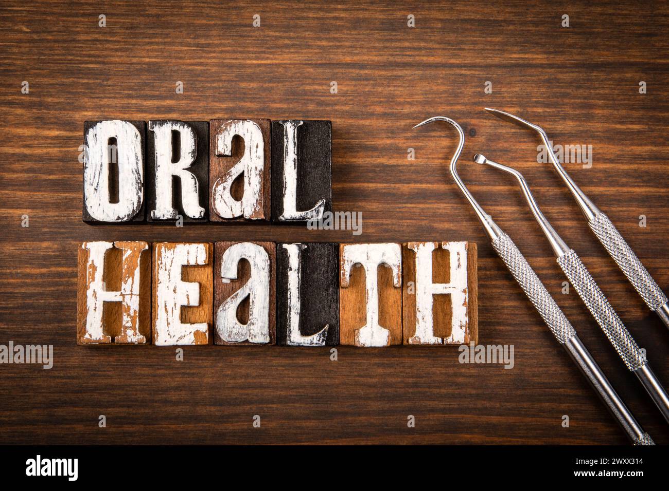 ORAL HEALTH. Alphabet blocks and dental tools on wooden background ...