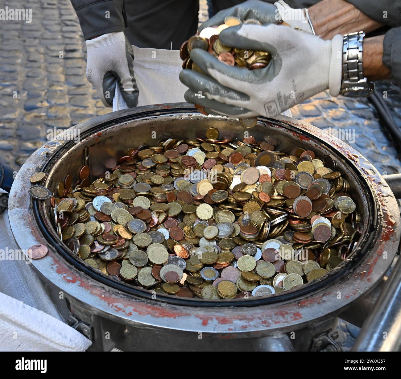 Rome, Italy. 2nd Apr, 2024. City workers pile up coins collected from ...