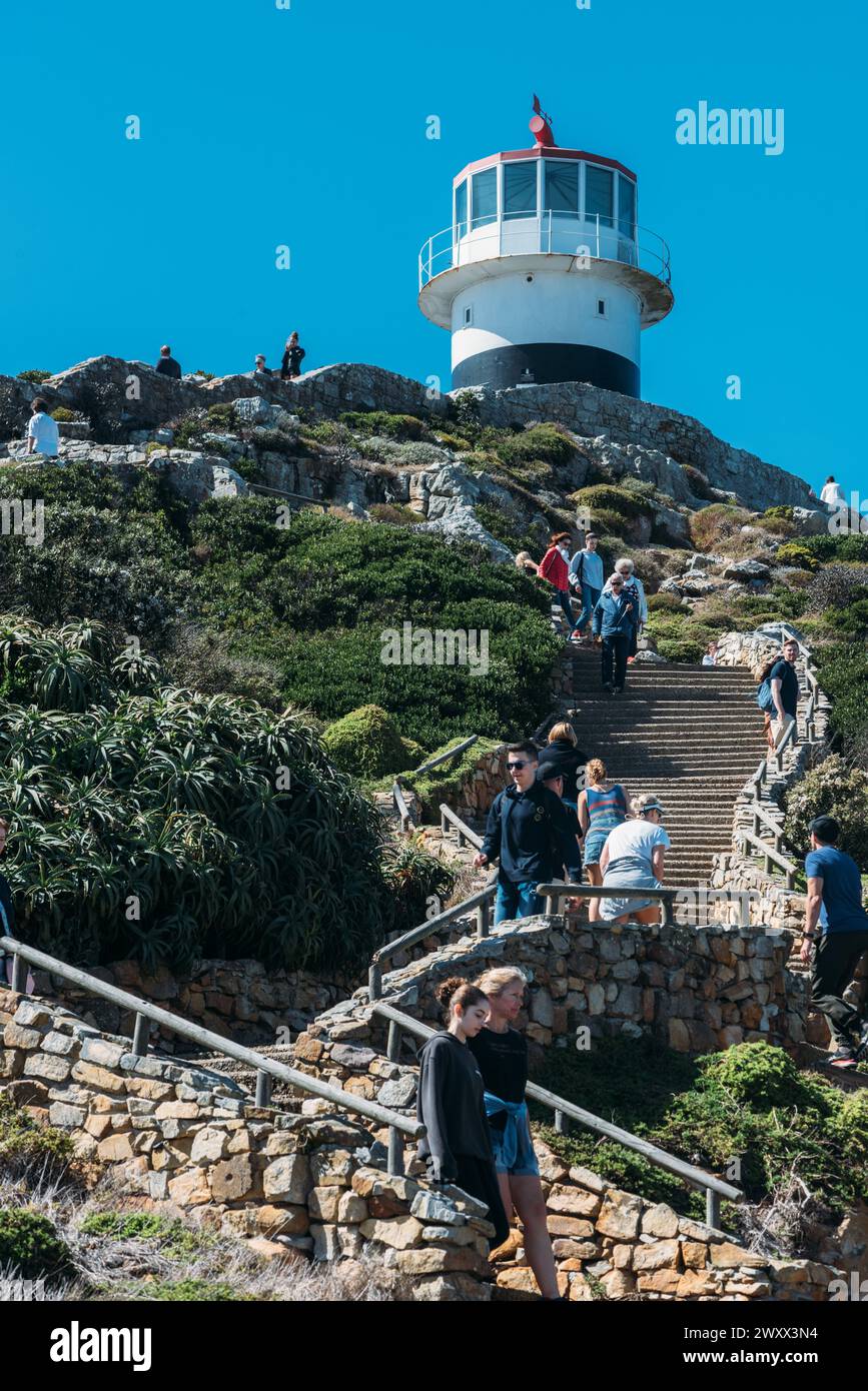 A group of tourists climbing a stone staircase towards a prominent ...