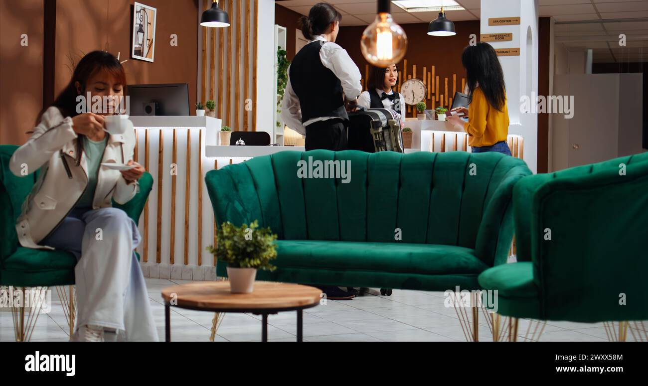 Employee giving room access card and passport to client after doing ...