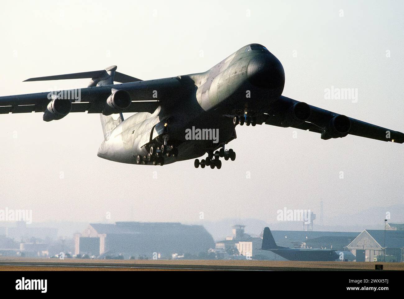 A right front view of a C-5 Galaxy aircraft approaching for a landing ...