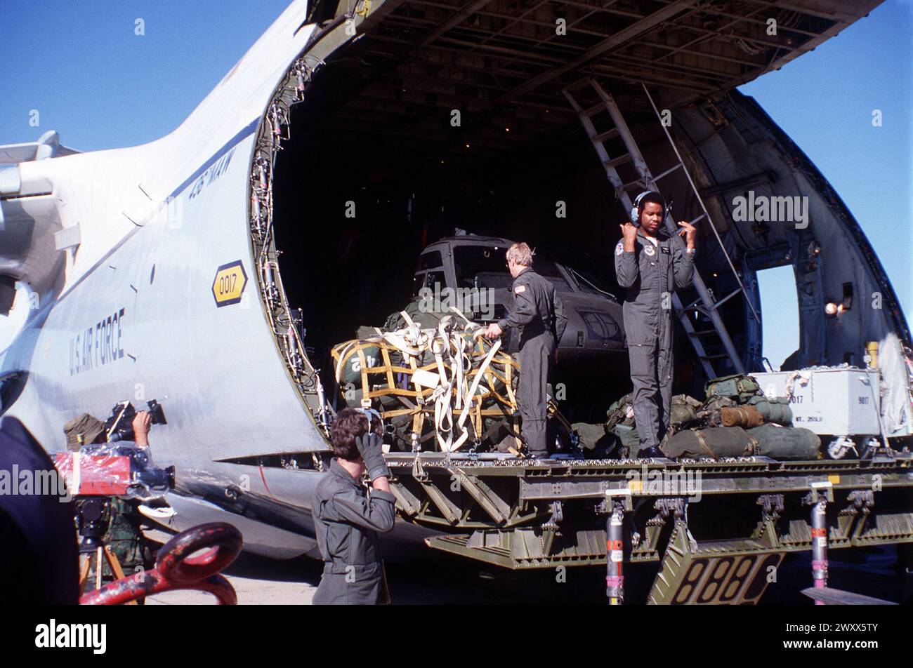 U.S. troops unload supplies from a C-5 Galaxy aircraft during exercise ...