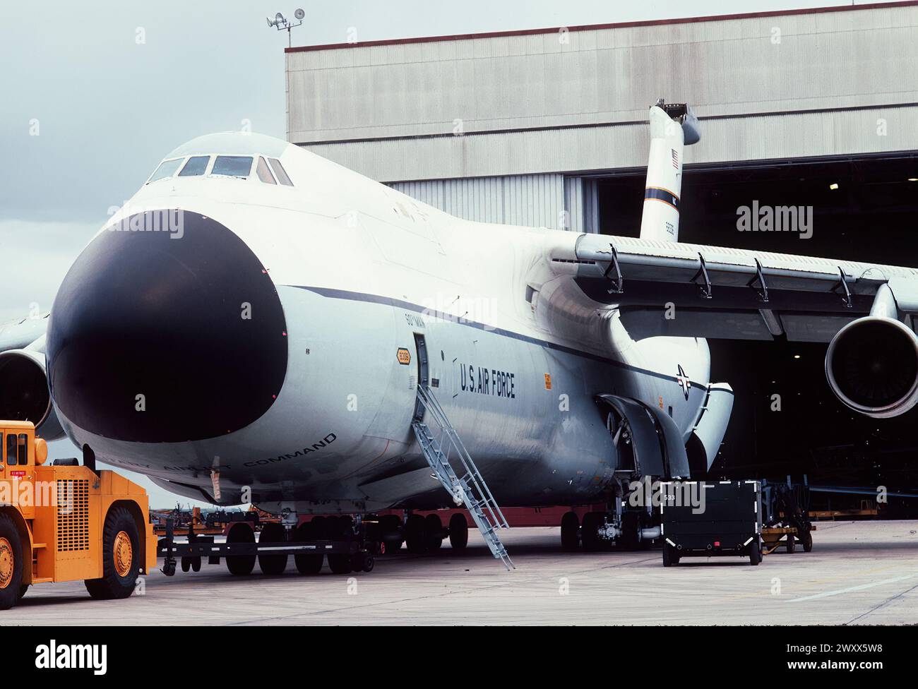 A left front view of a C-5 Galaxy aircraft parked outside a hangar at ...