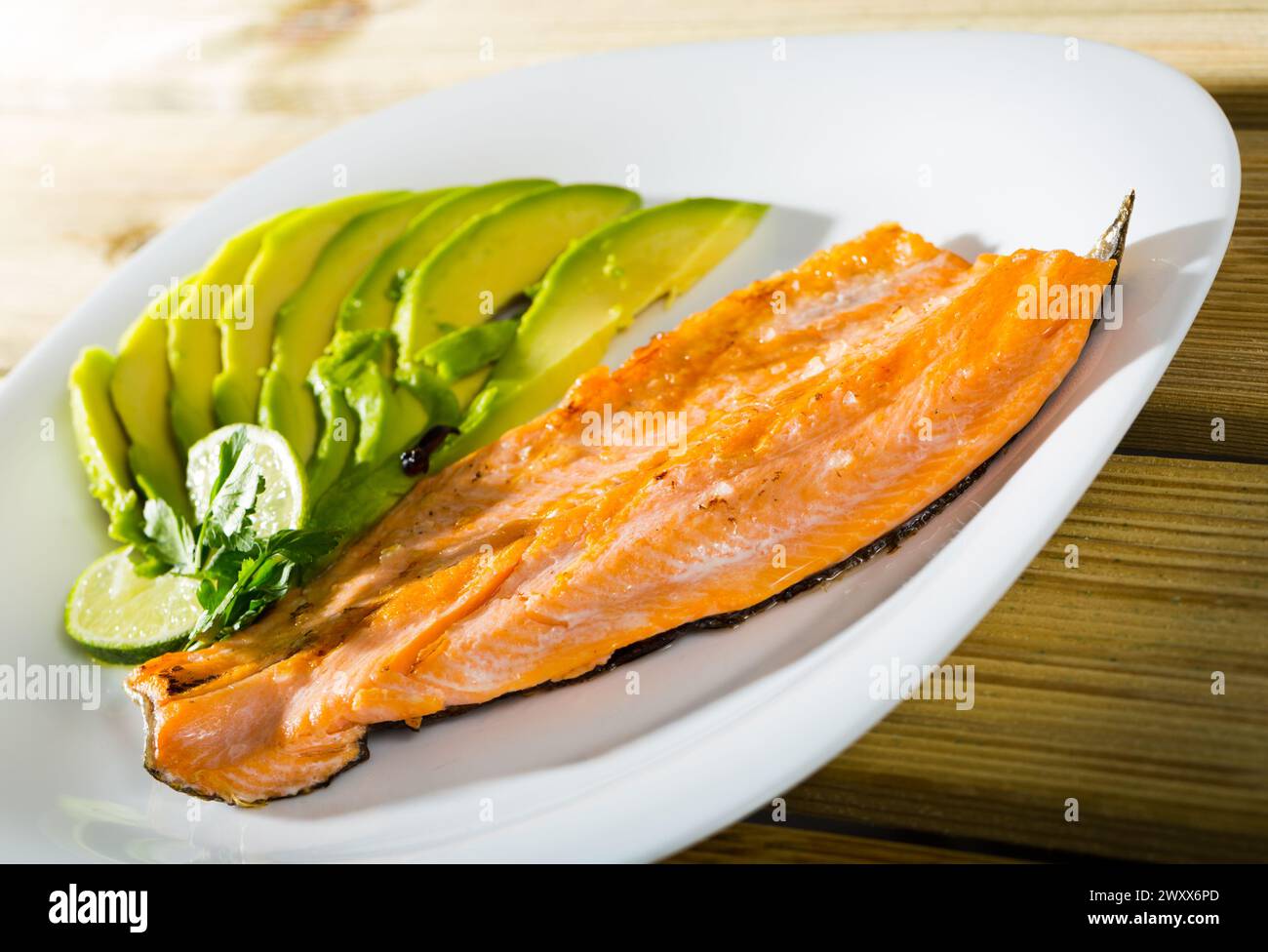 Photography of plate with fried trout fillet with avocado Stock Photo ...