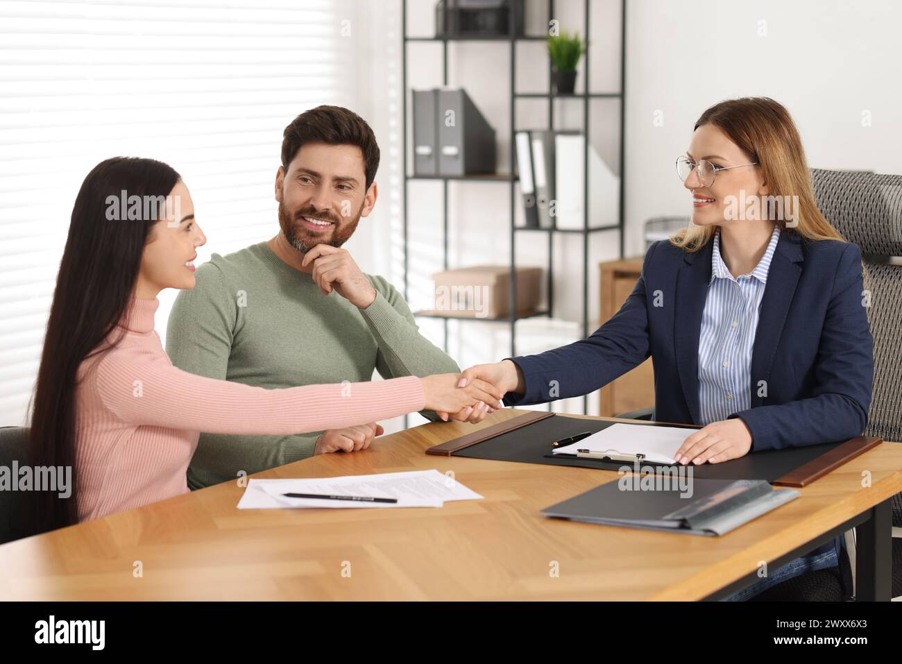 Lawyer shaking hands with clients in office Stock Photo - Alamy