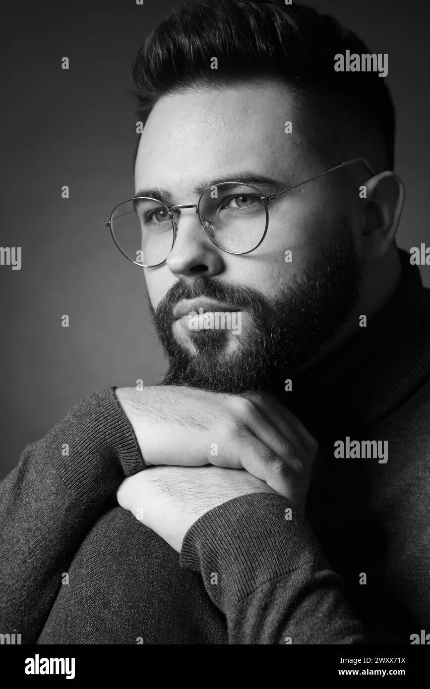 Portrait of handsome bearded man on dark background. Black and white ...