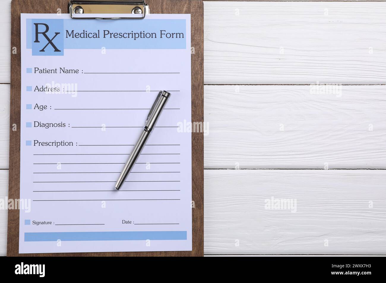 Medical prescription form with empty fields and pen on white wooden ...