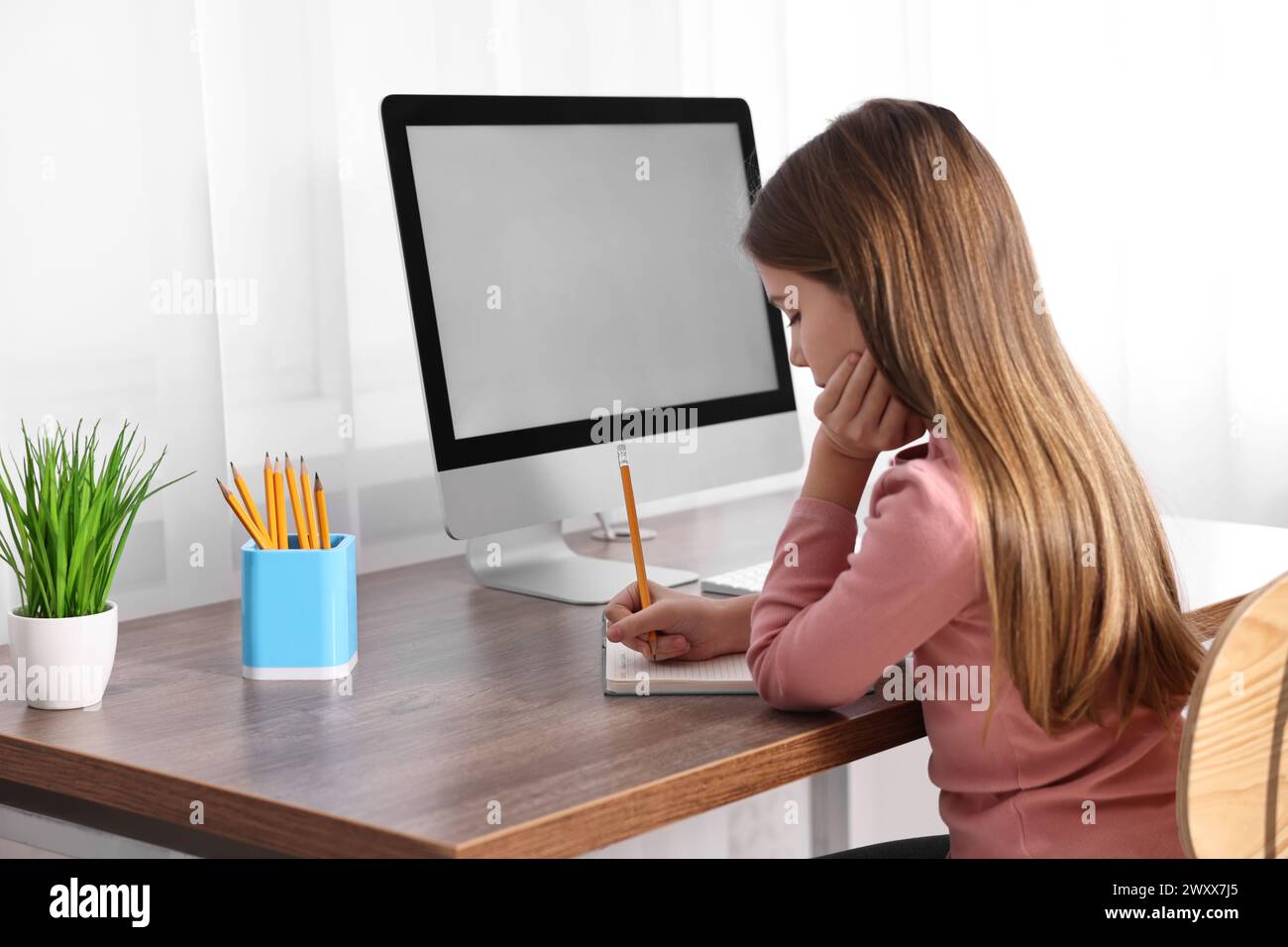 Girl writing during lesson hi-res stock photography and images - Alamy