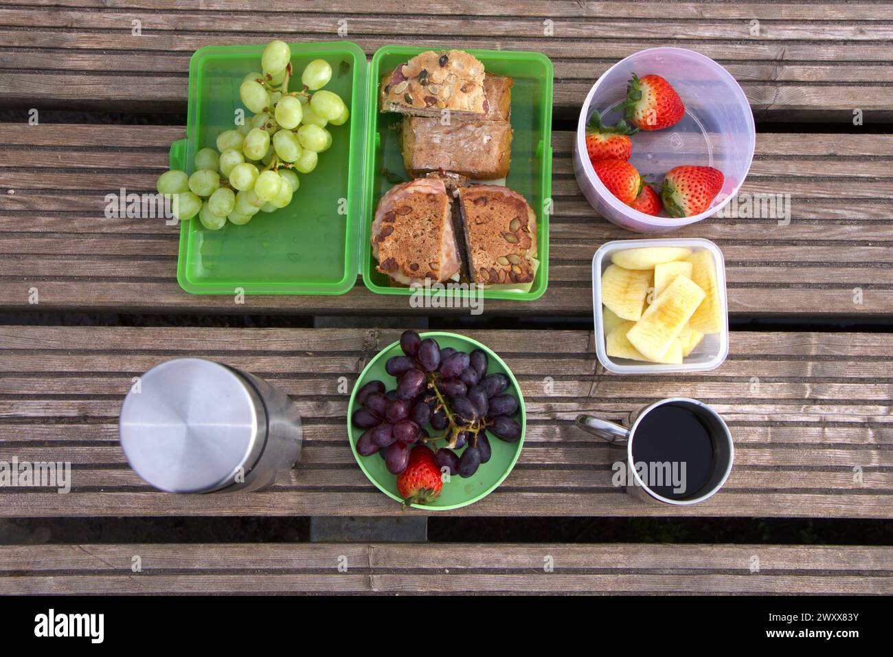 well-arranged assortment of food items on wooden surface, outdoor ...