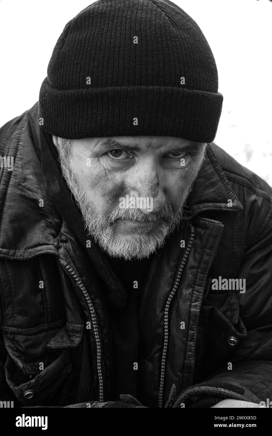 Portrait of poor homeless man with hat outdoors Stock Photo - Alamy