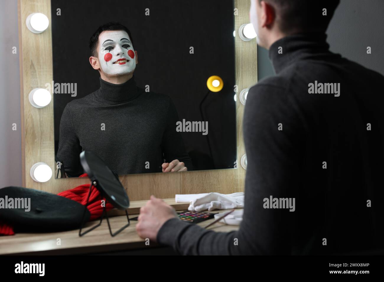 Mime artist posing near mirror in dressing room Stock Photo - Alamy