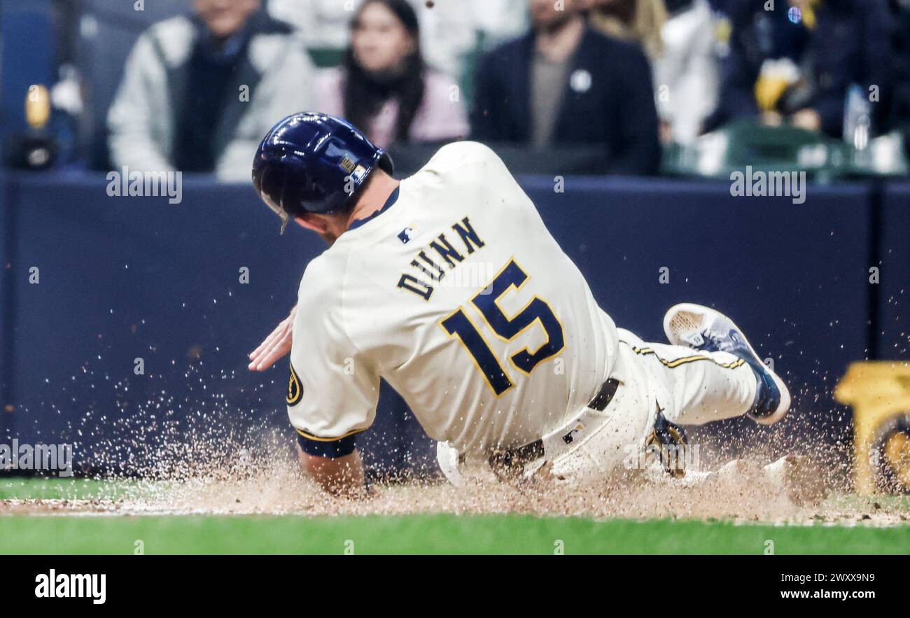 Milwaukee Brewers third baseman Oliver Dunn (R) scores against the ...