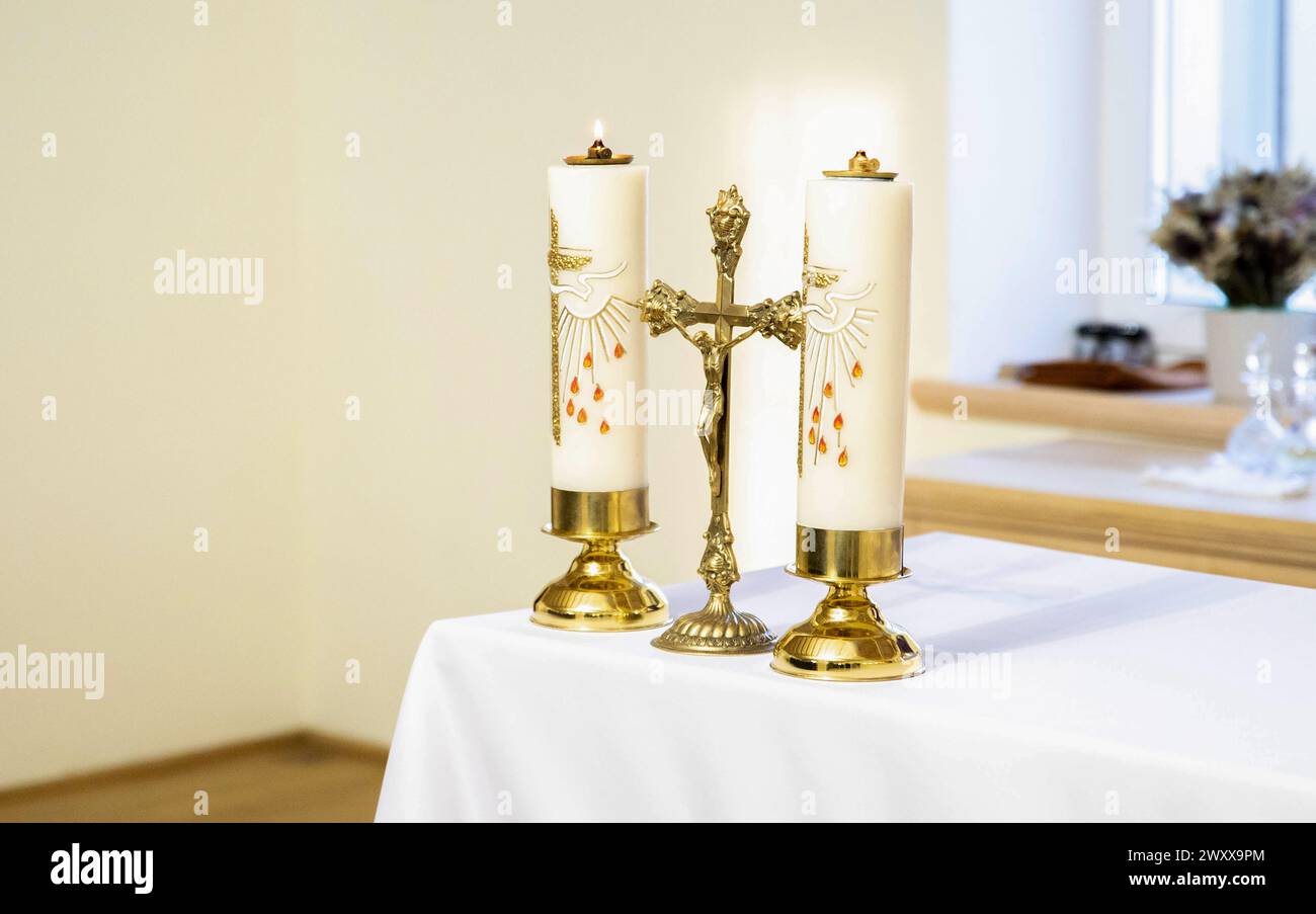 Wooden cross, snowdrops flowers and candles on table, abstract ...
