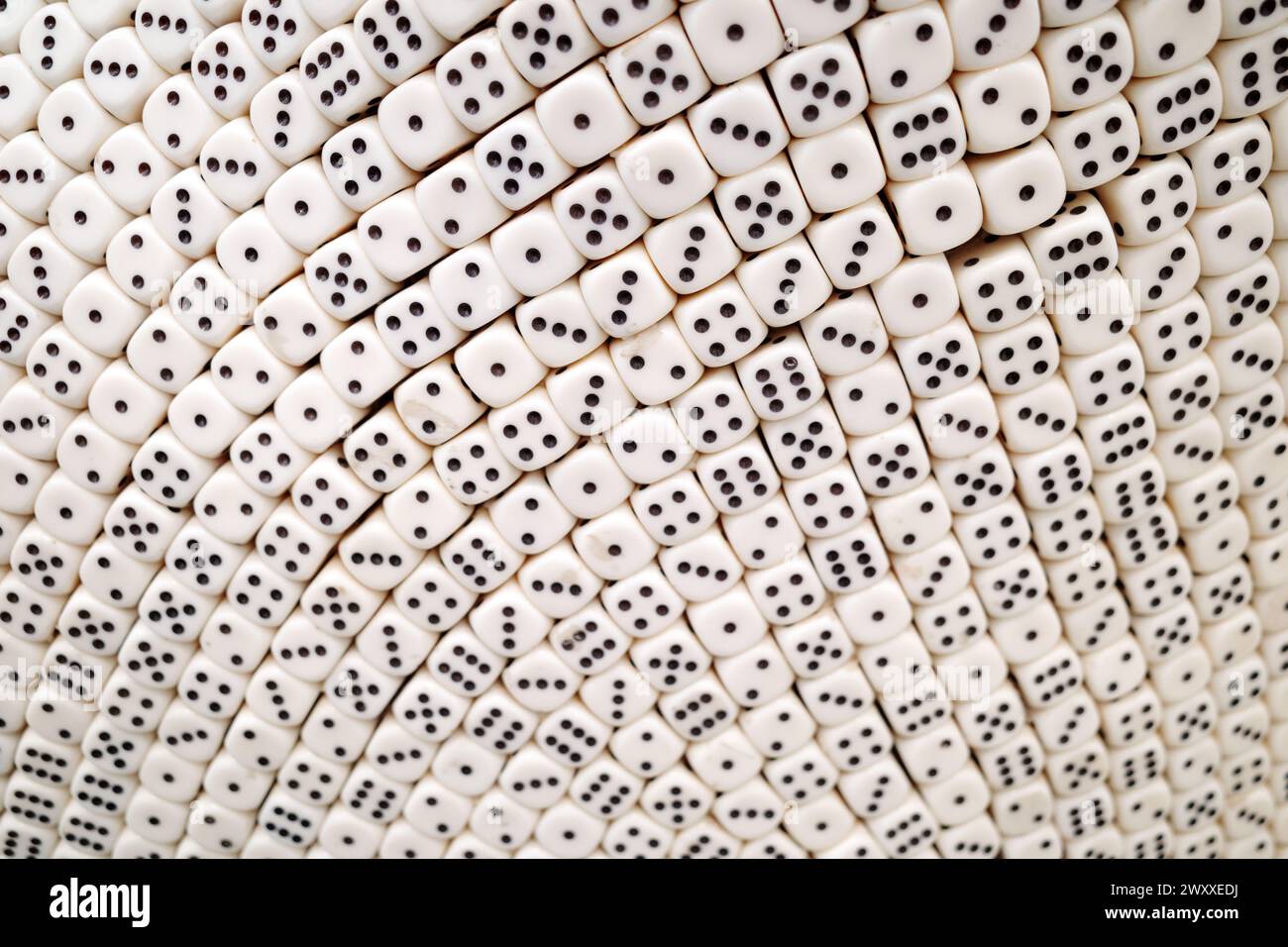 A close-up view of a large collection of six-sided dice neatly arranged ...