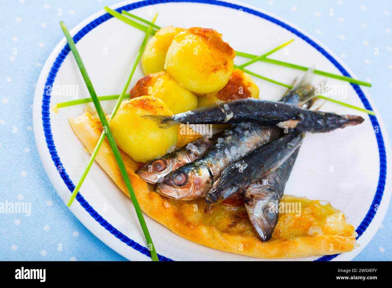 Roasted pilchards with potato balls and focaccia Stock Photo - Alamy