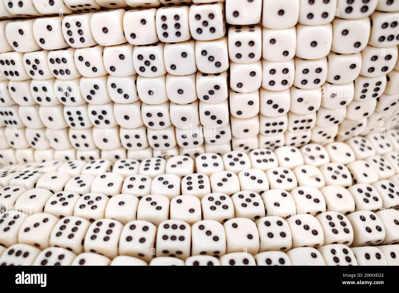 A close-up view of a large collection of six-sided dice neatly arranged ...