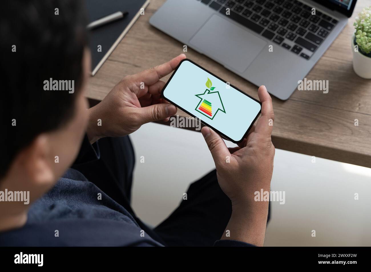 Businessman use phone Energy efficiency mobile app on screen Chart And ...