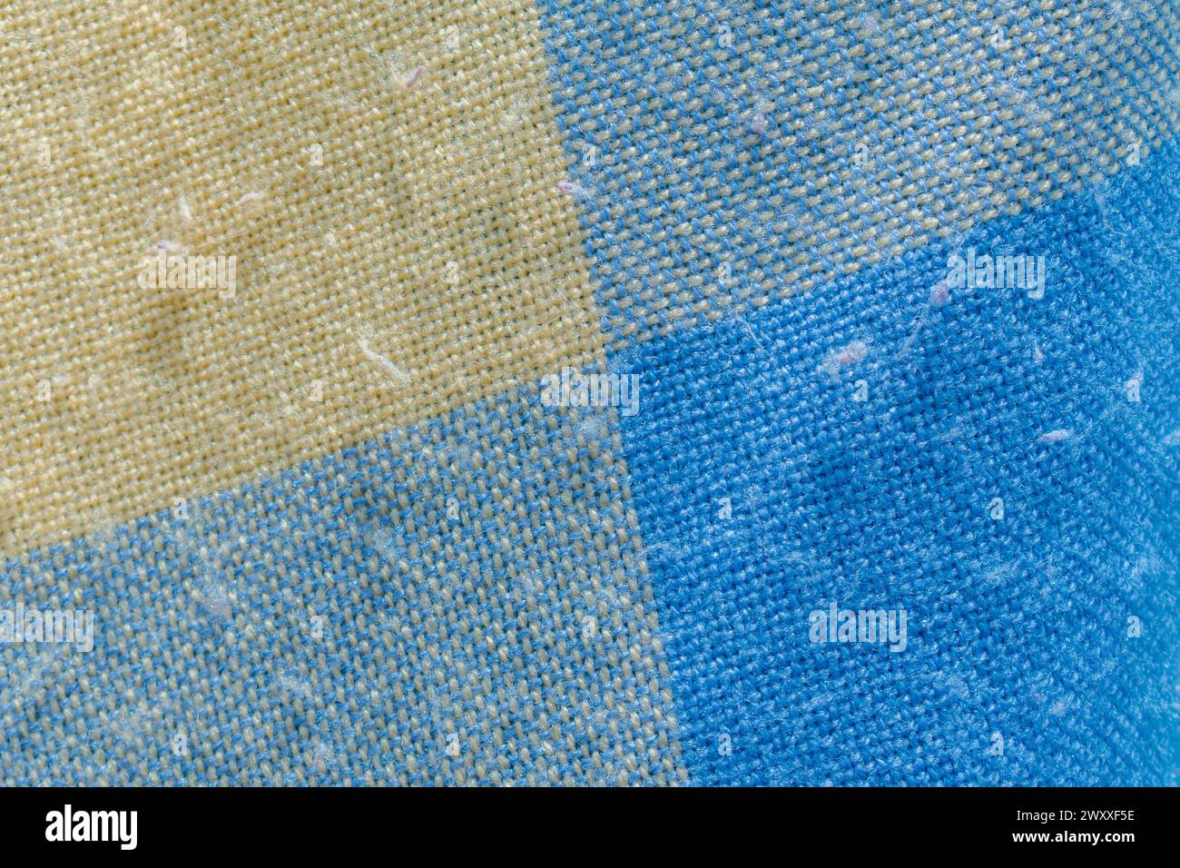 detail of colored wool fabric worn by use with some specks on it ...