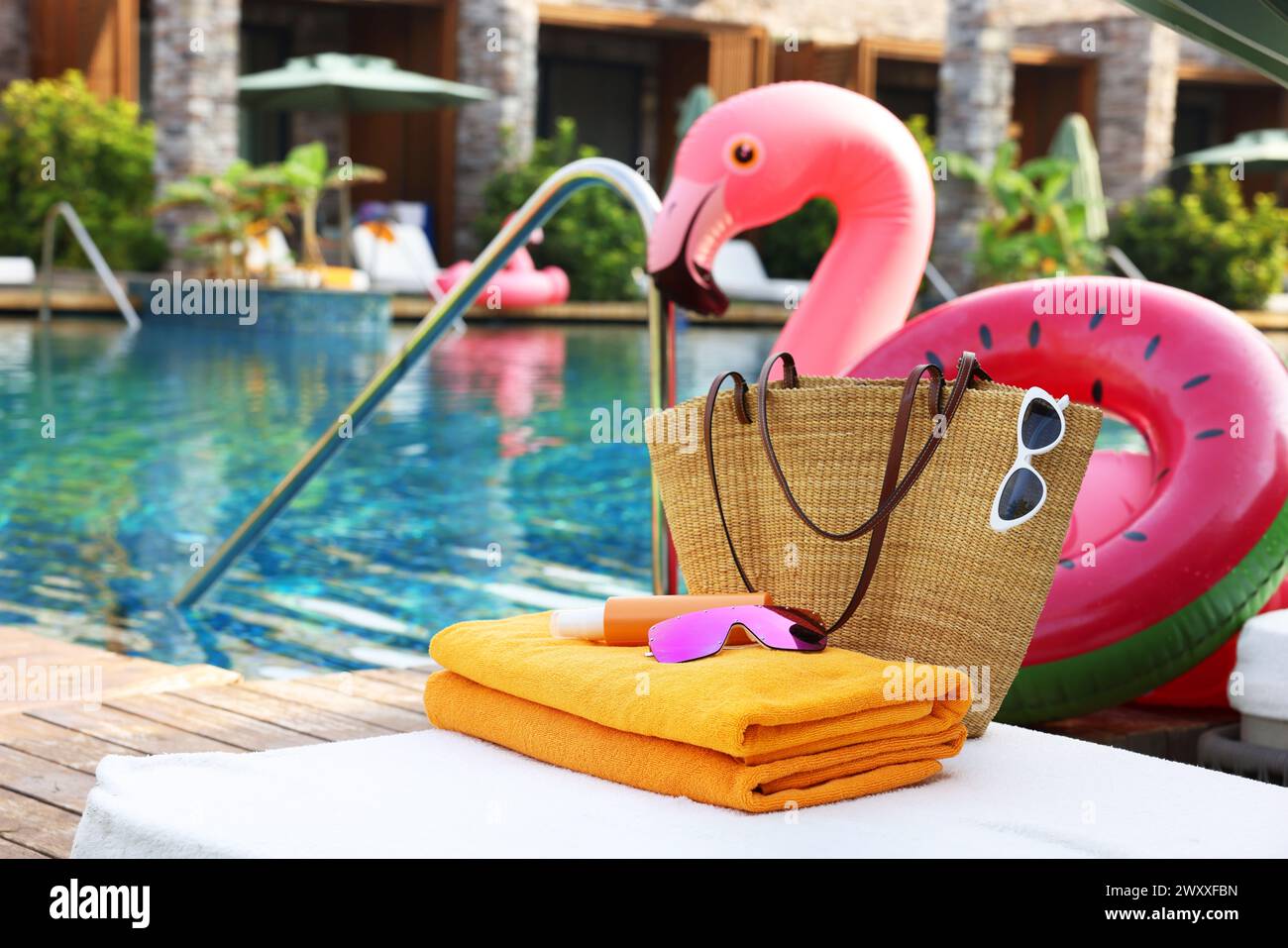 Beach accessories on sun lounger, inflatable ring and float near ...