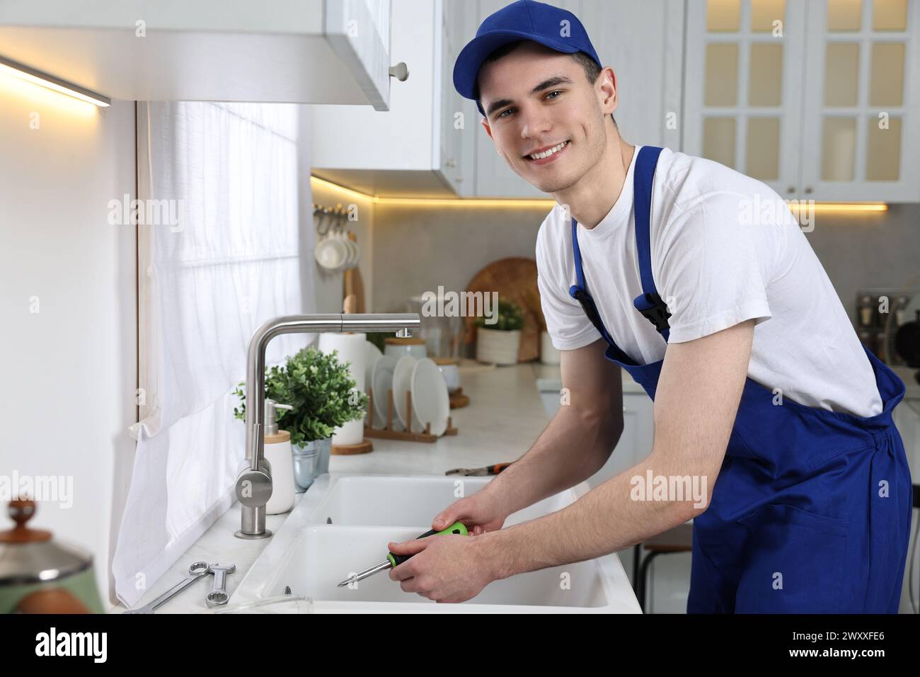 Handsome plumber repairing drain sink hi-res stock photography and ...