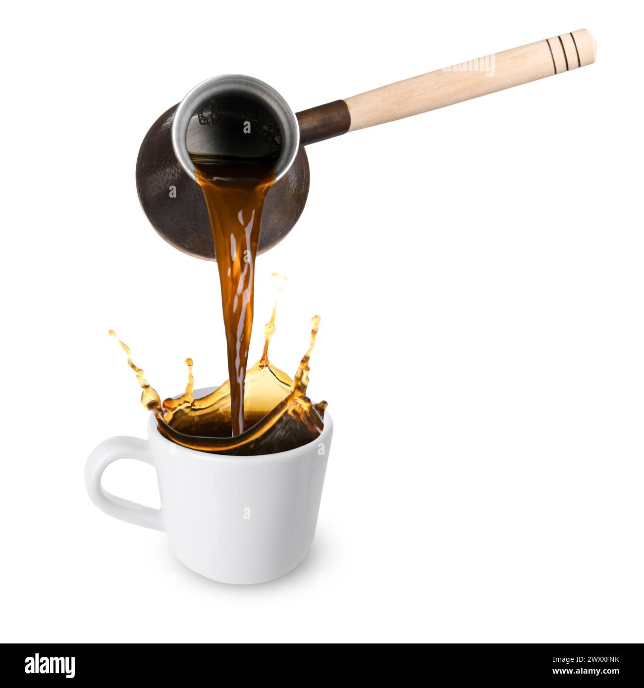 Pouring freshly brewed aromatic coffee from turkish pot into cup ...