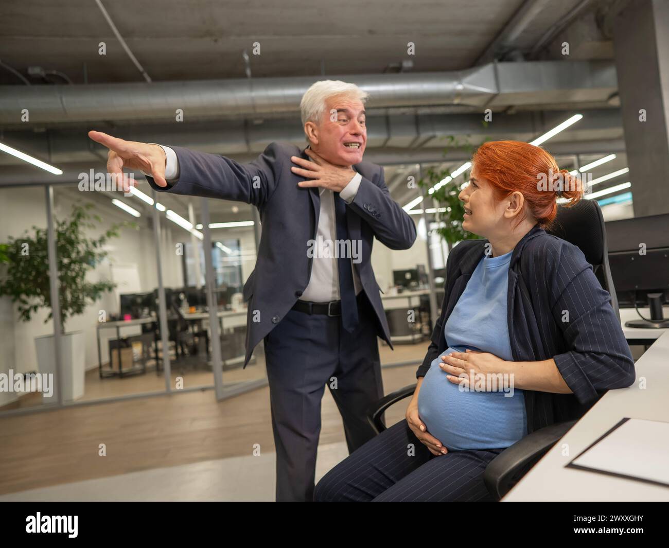 Boss fires pregnant subordinate woman from work Stock Photo - Alamy