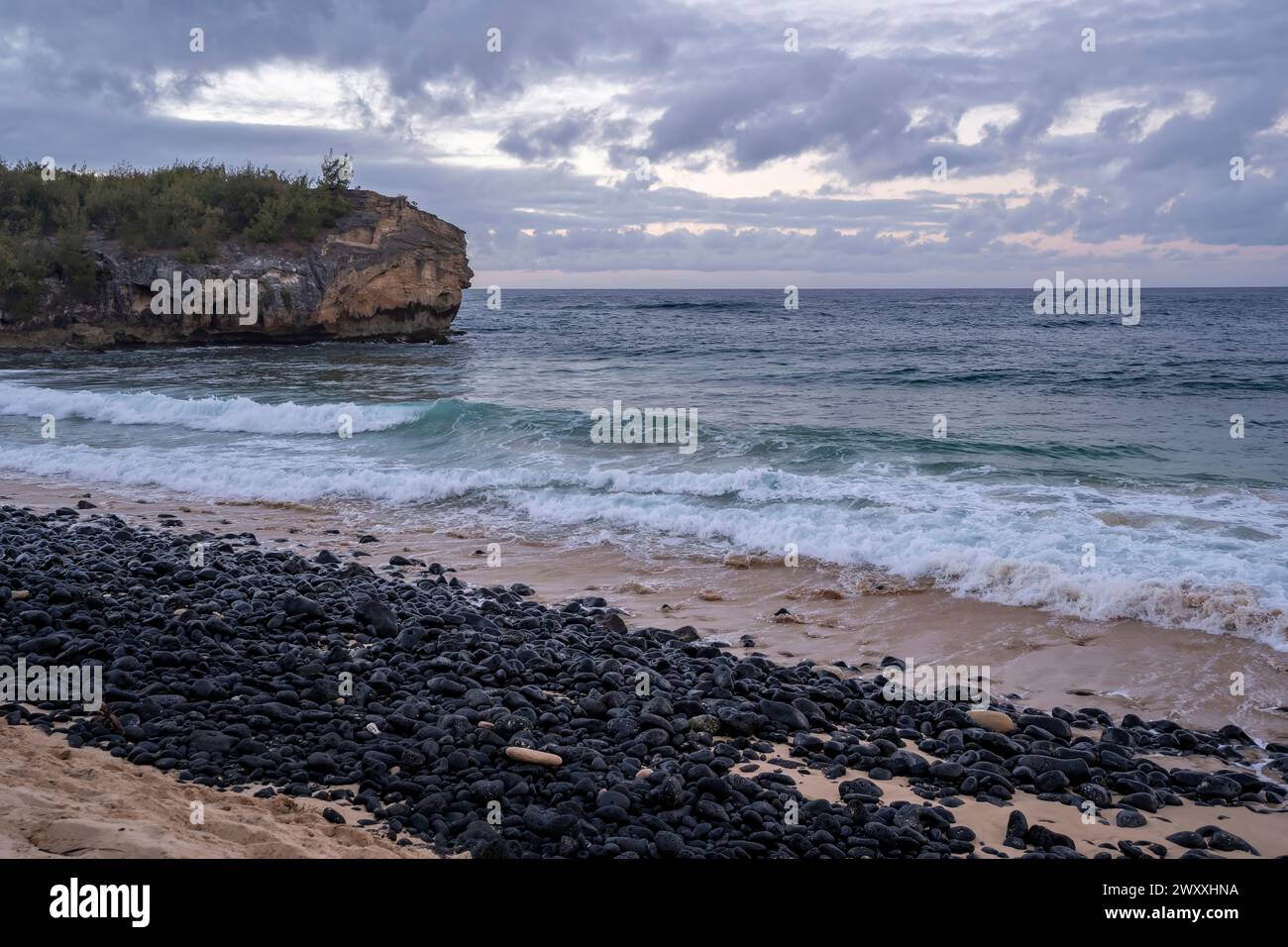 Rough Pacific waves crash into jagged cliffs along Shipwreck Beach in ...