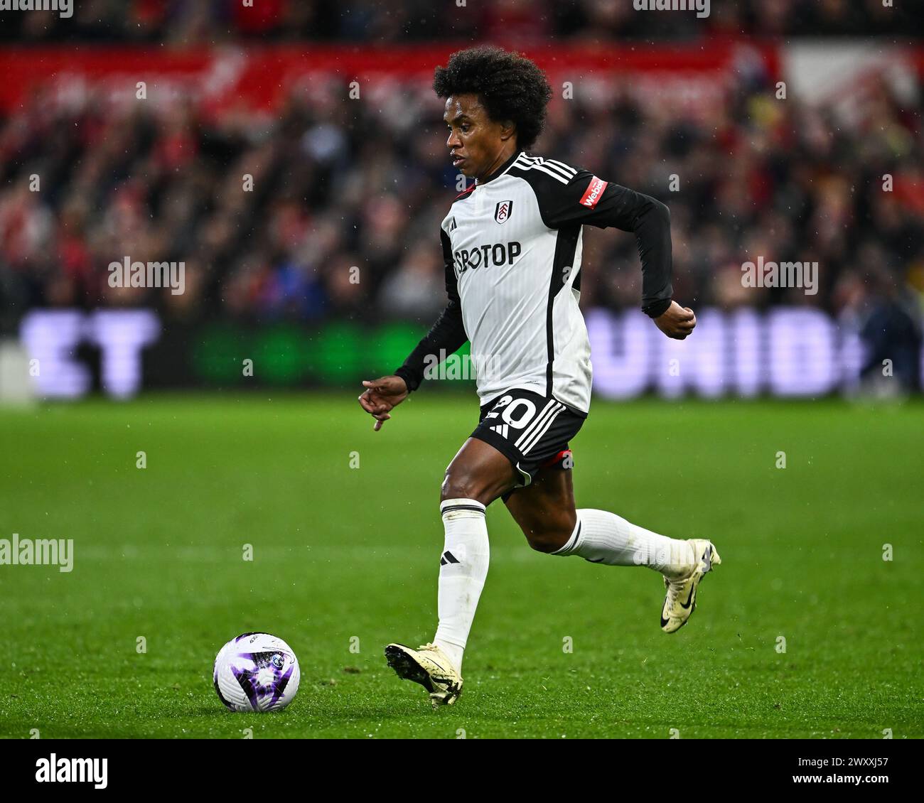 Willian of Fulham makes a break with the ball during the Premier League ...