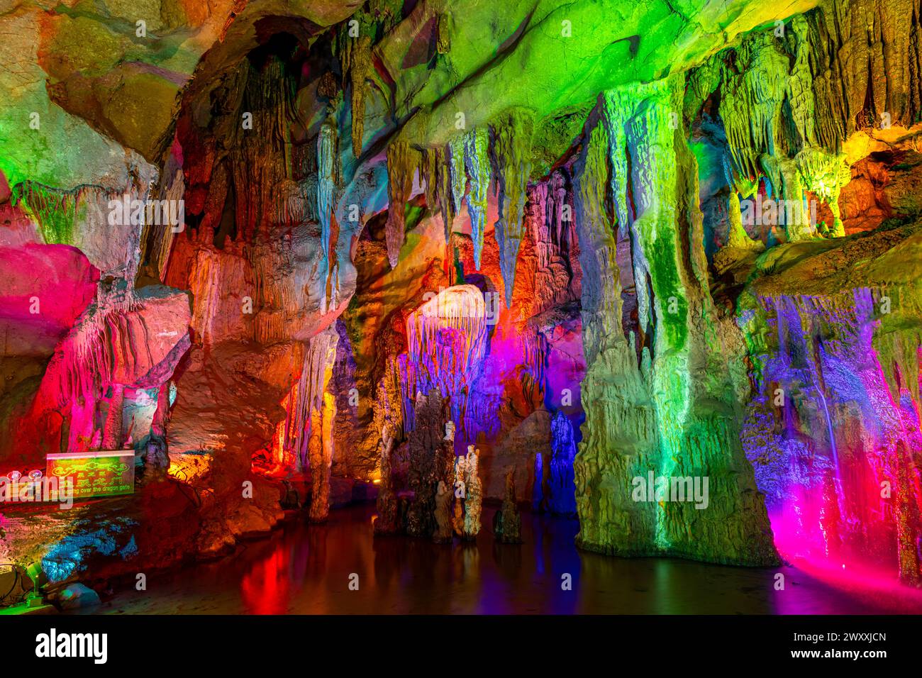 Inside the cave. Stalactites, stalagmites, colored light. Beautiful ...