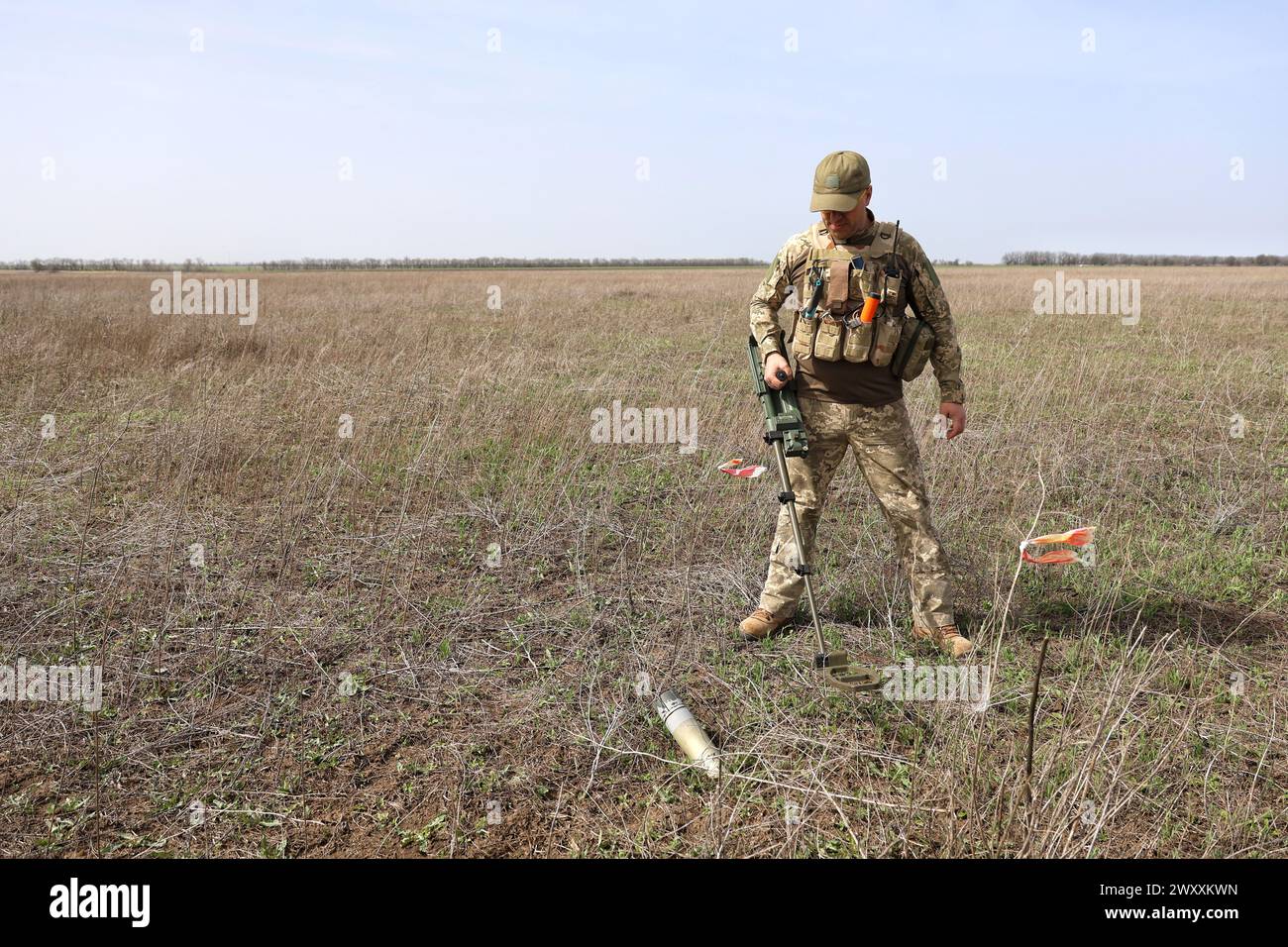 MYKOLAIV REGION, UKRAINE - APRIL 02, 2024 - A serviceman with a metal ...