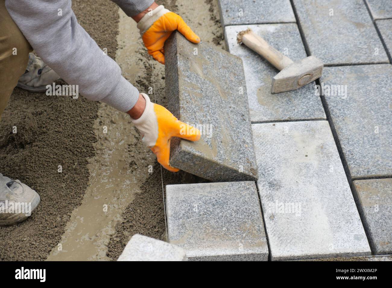 a worker laying concrete bricks on each other for building a new ...