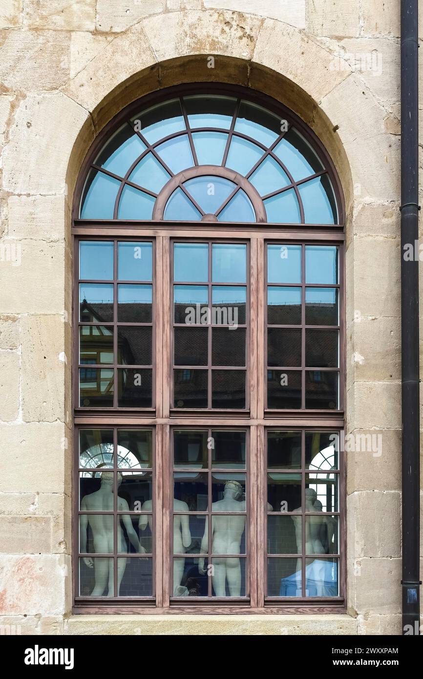 From behind sculptures, male figures, cast collection in the window ...