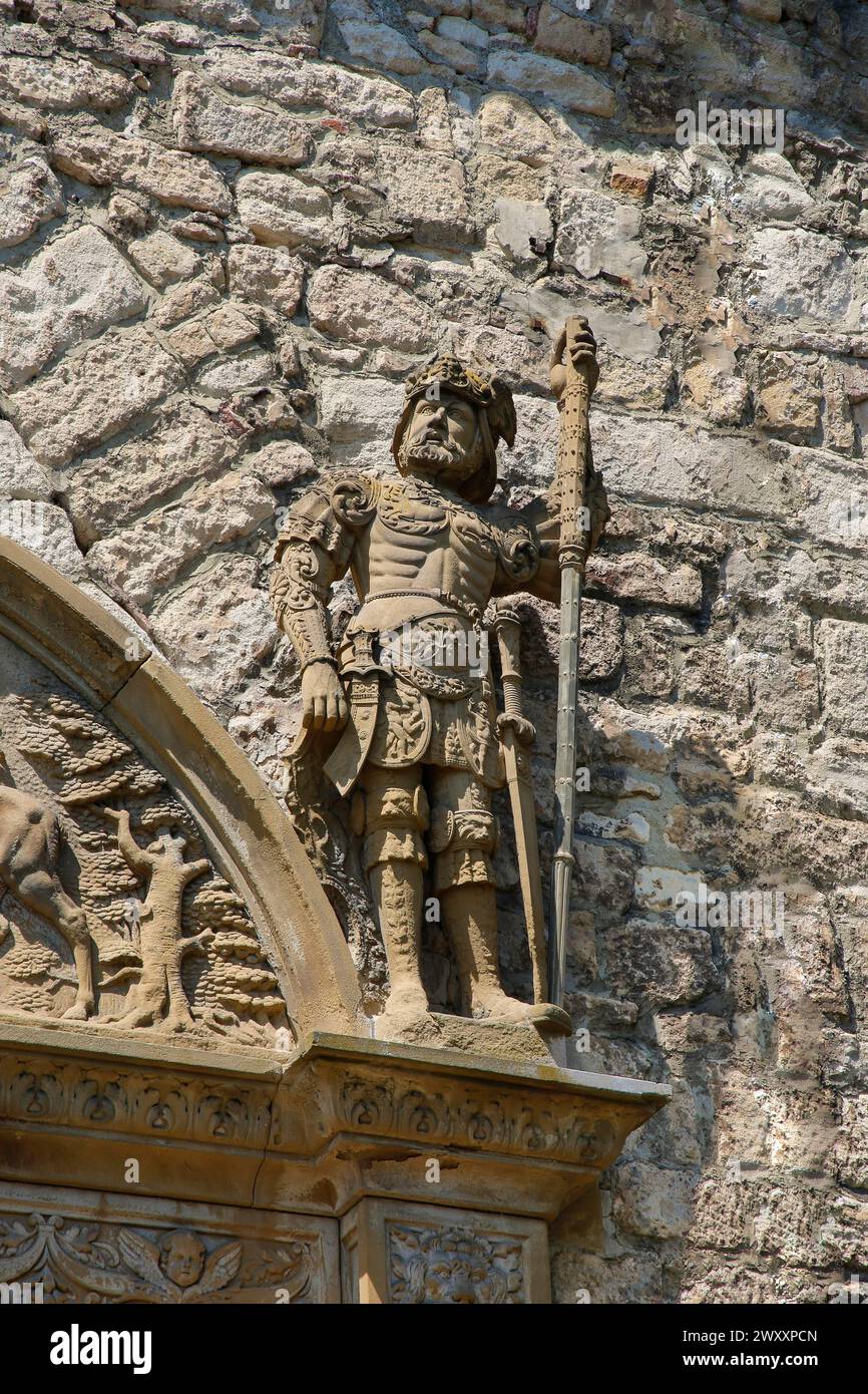 Stone figures, statue, male warrior above portal, detail, armour ...