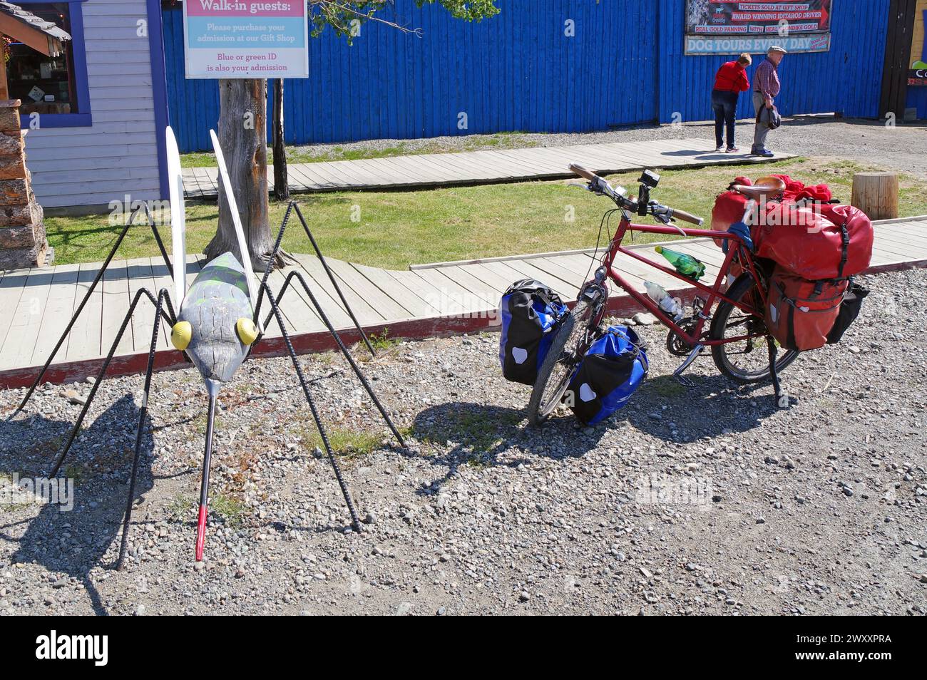 Bicycle with luggage next to an oversized mosquito, Carcross, Yukon Territory, Canada Stock ...
