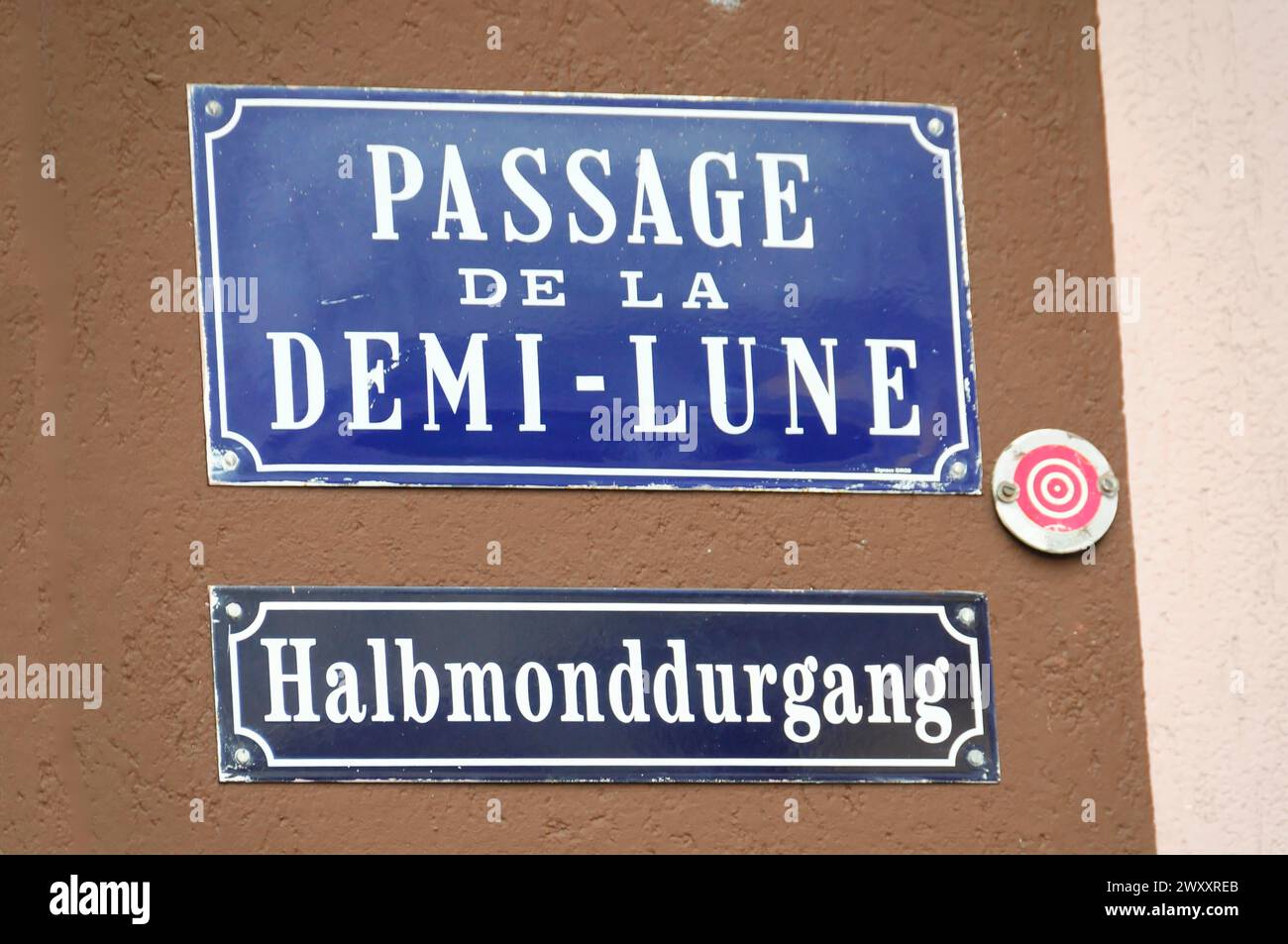 Blue road signs in French and German with arrow and symbol, Mulhouse ...