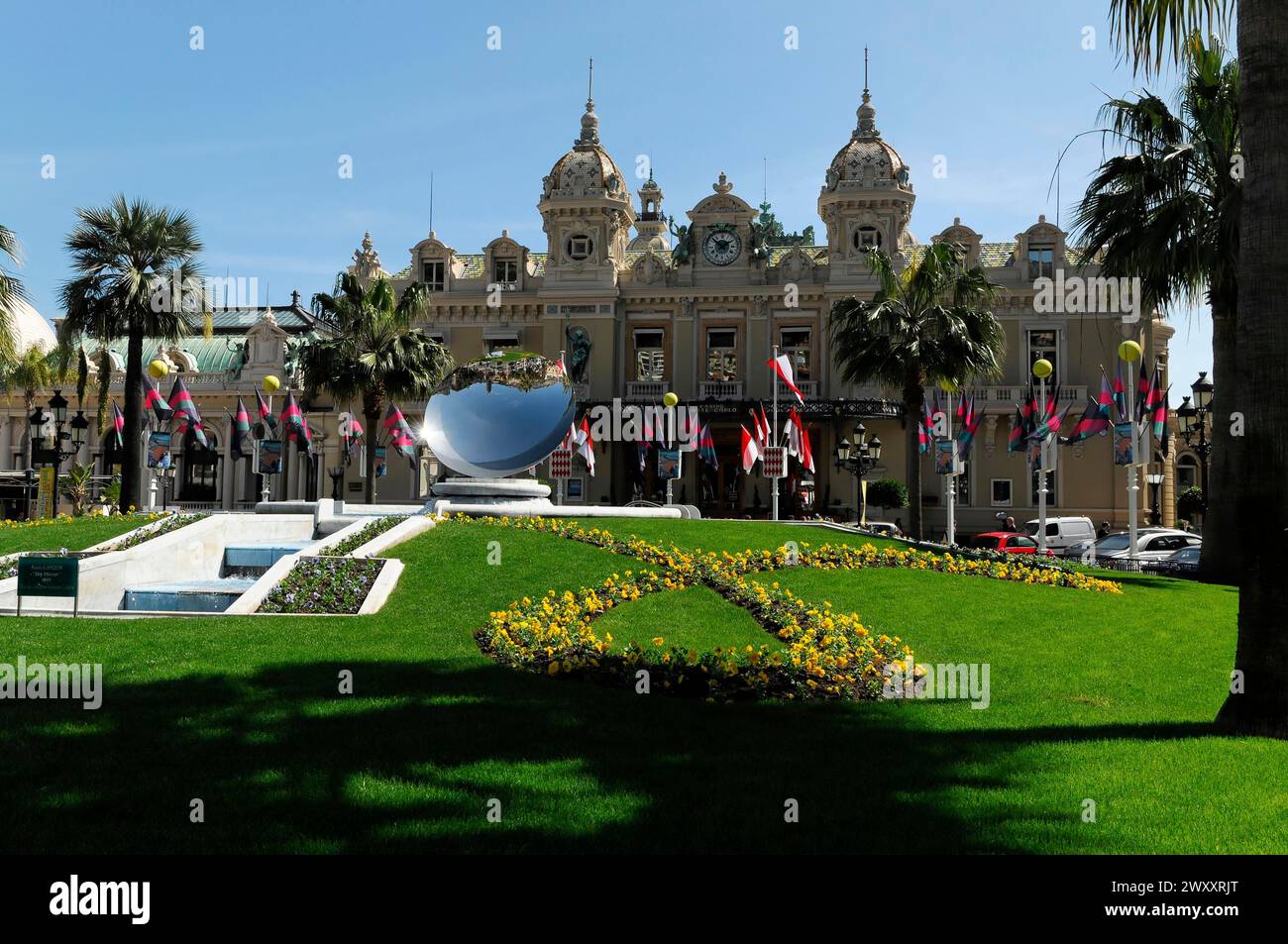 Historic casino in Monte Carlo with flags and modern art object in ...
